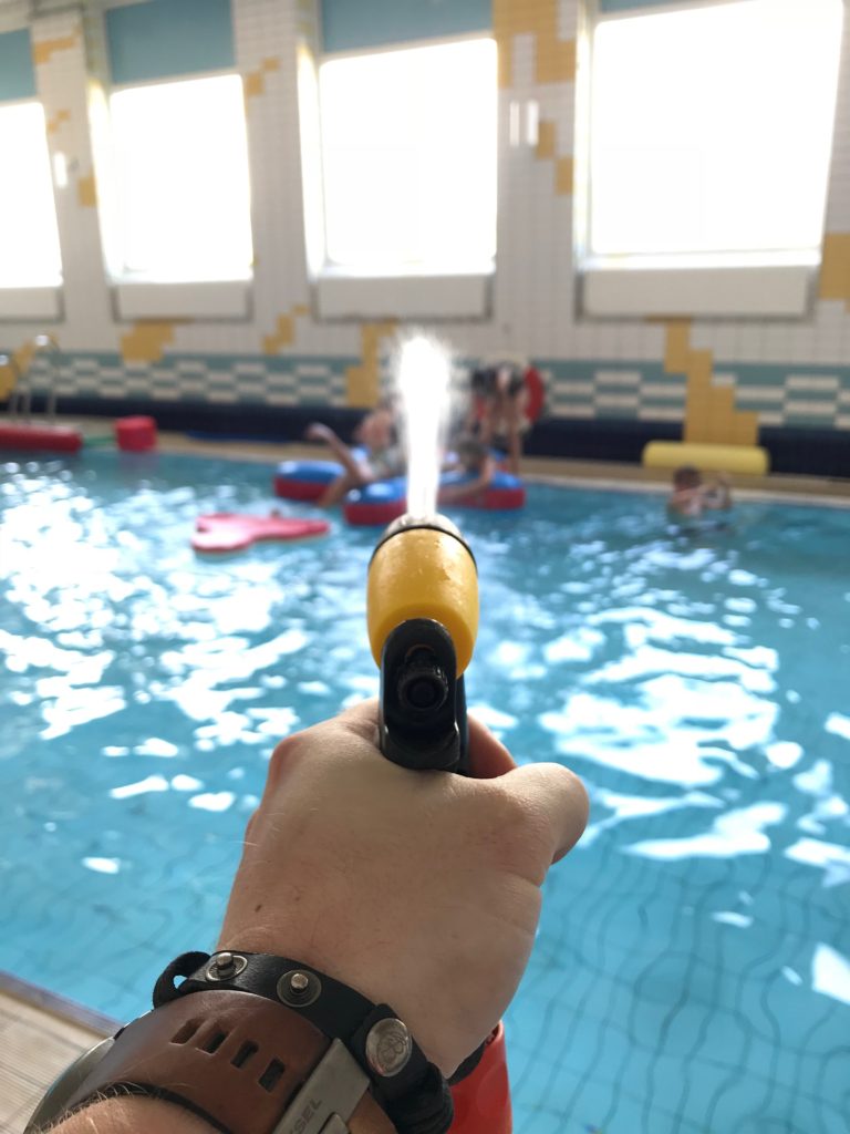Water Hose Gun Sparying Water Into Pool With Kids And Toys - The Best ...